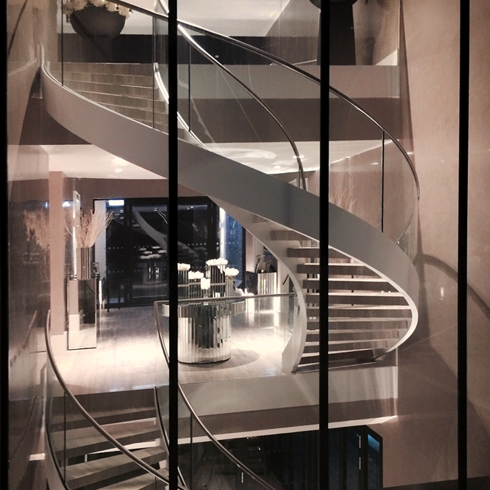 Curved staircase with glass balustrade and American red oak treads ...