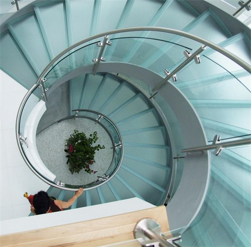 Fancy curved staircase design with glass steps
