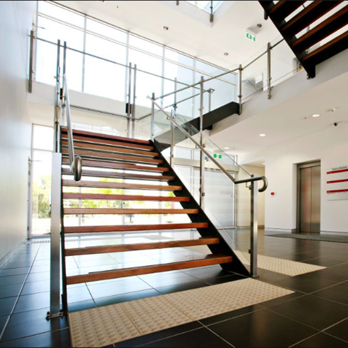 L shape wood stairs with glass railing for modern office staircase