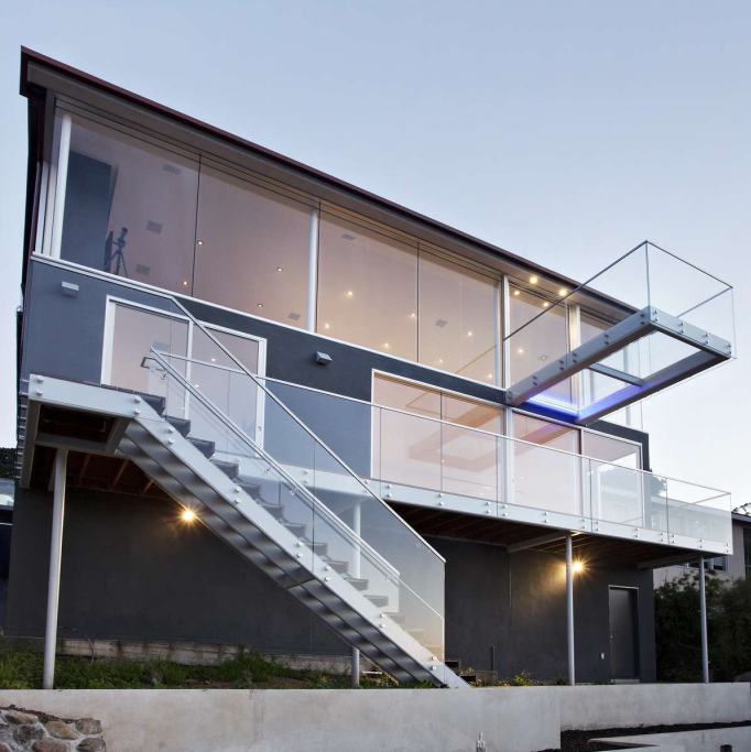 Exterior mono stringer staircase with wood tread and cable railing