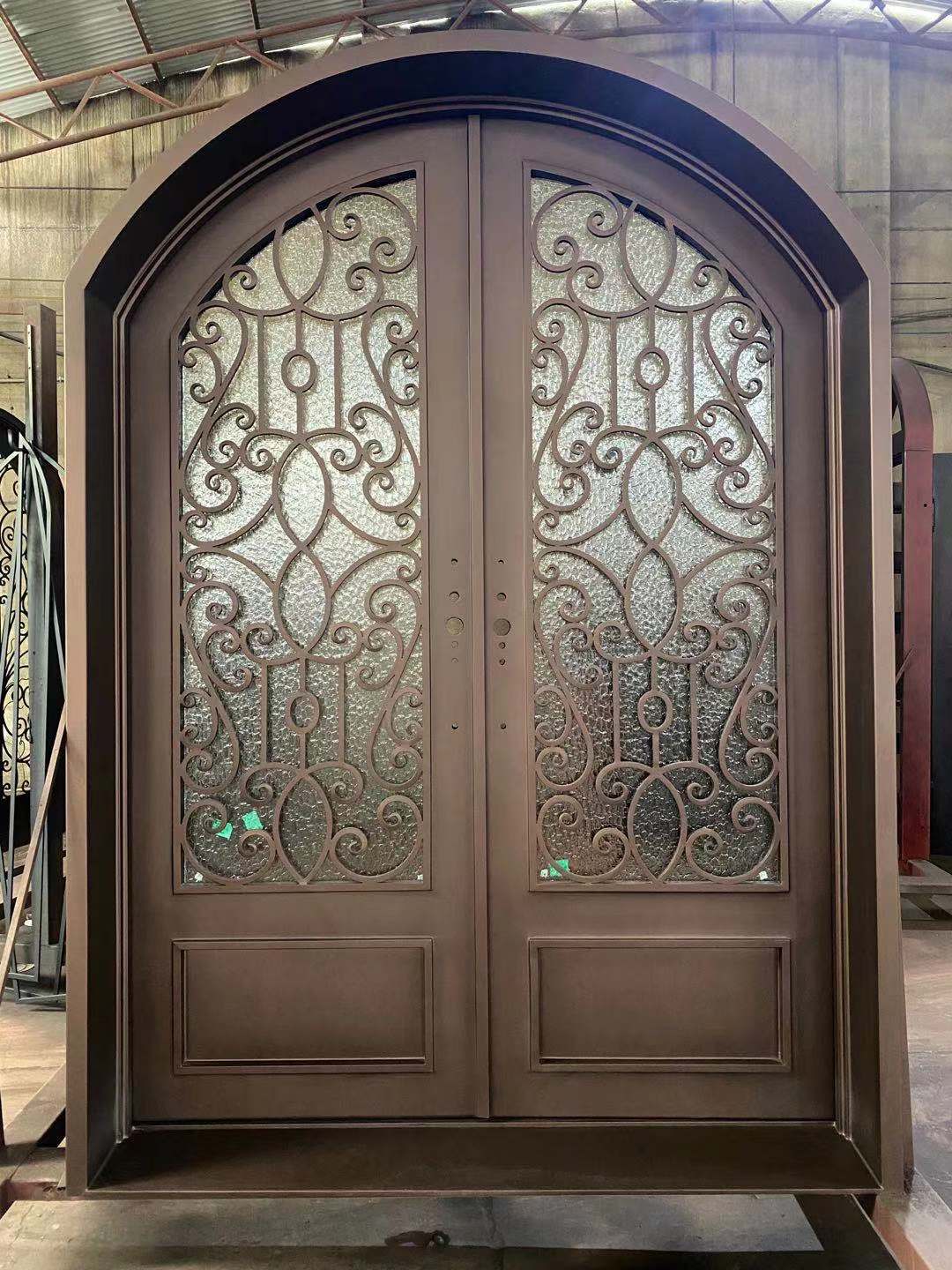 Double panel wrought iron front entry door with arc top in brown color ...