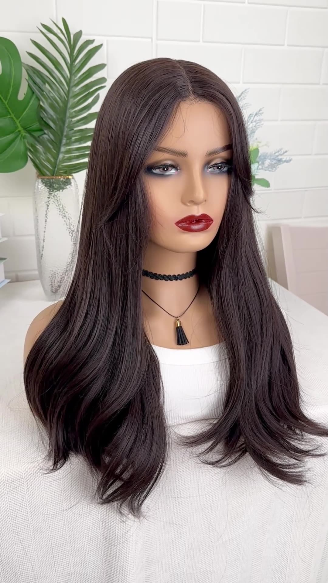 Natural-toned bangs with a center part and long curly hair